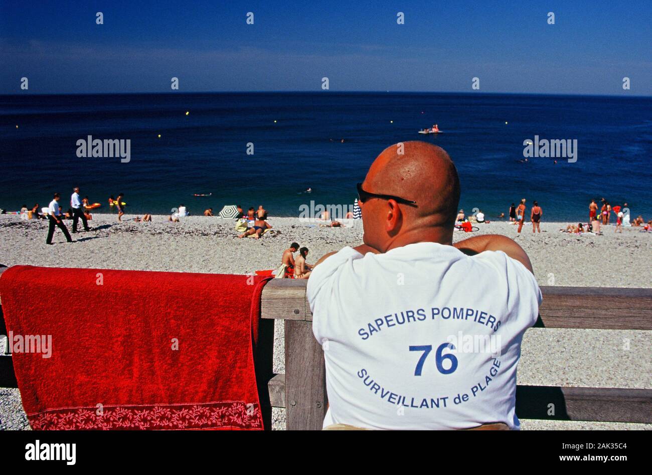 A lifeguard observes the beach in Etretat in the Seine-Maritime ...