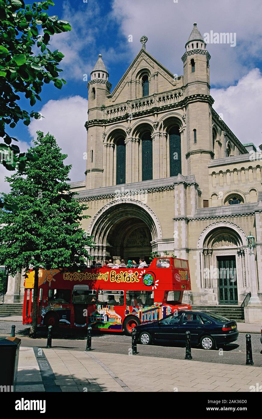 A red double-decker bus passing the Belfast Cathedral that was built ...
