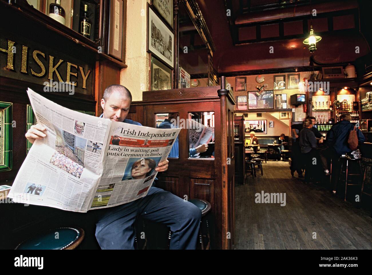 A man sitting in one of the traditional reading booths in the McDaid's ...
