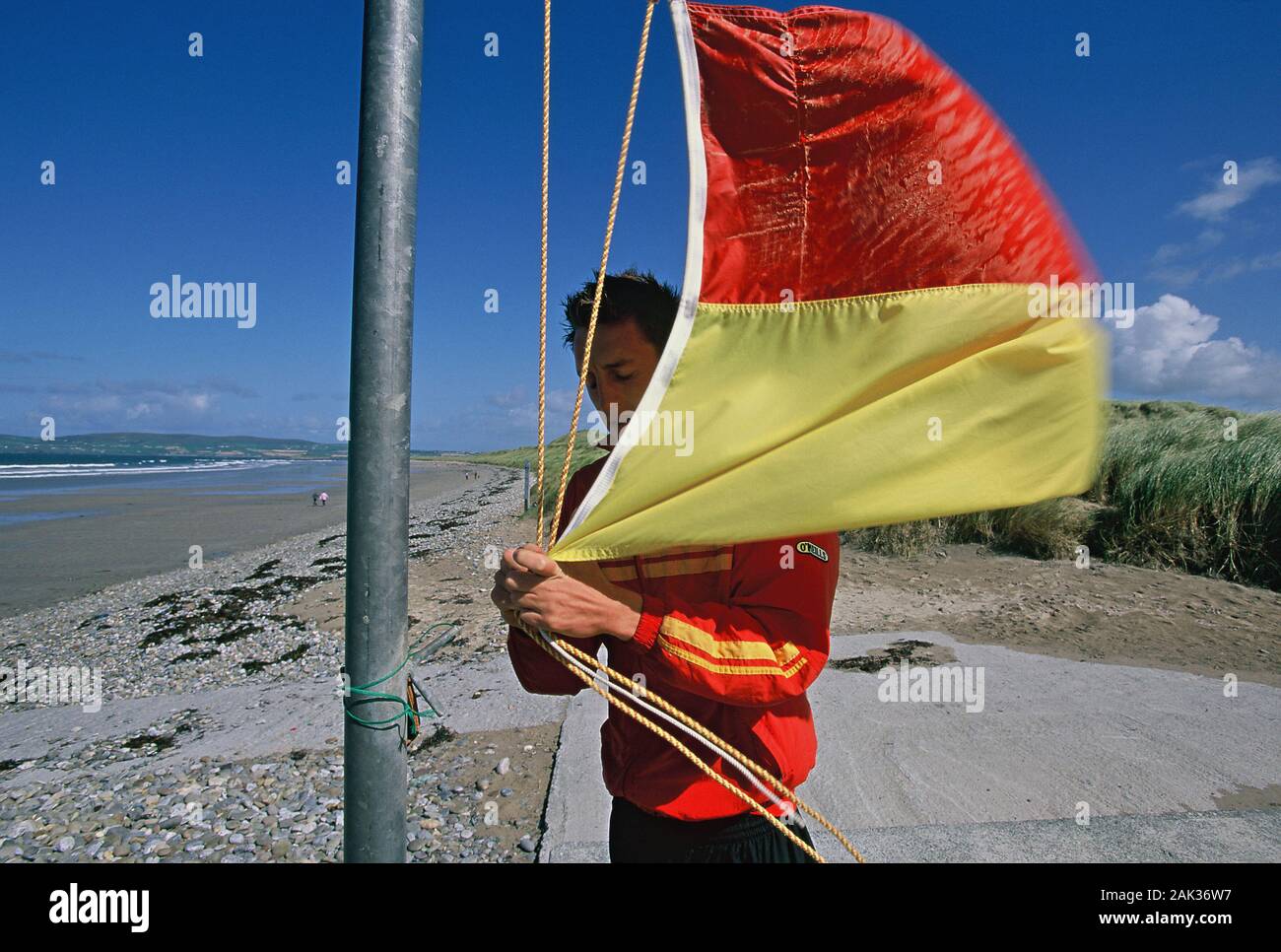 A lifeguard flying a warning flag at the beach of Tralee in the south ...