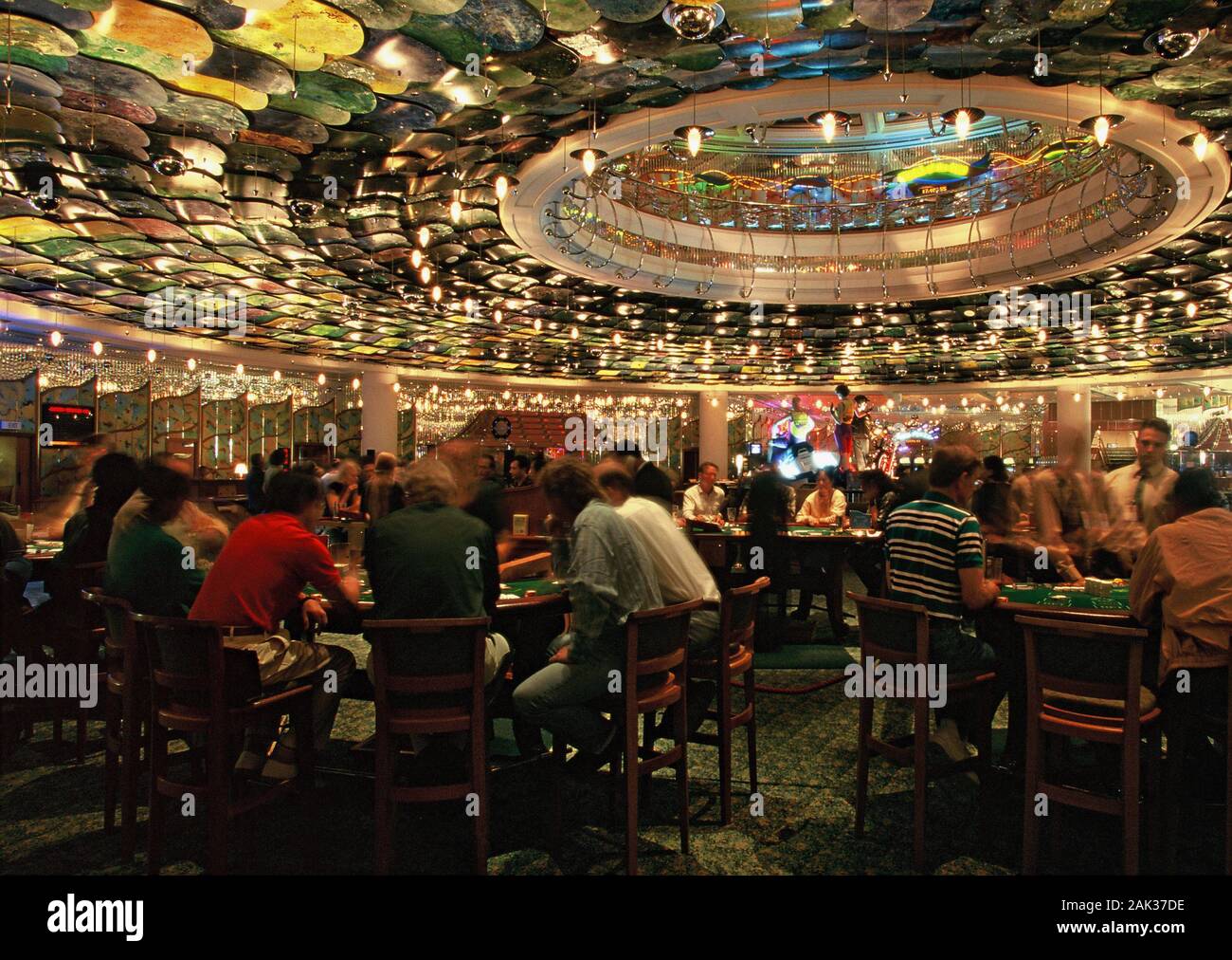 People sitting at gambling tables in the Casino of Cairns in Queensland ...