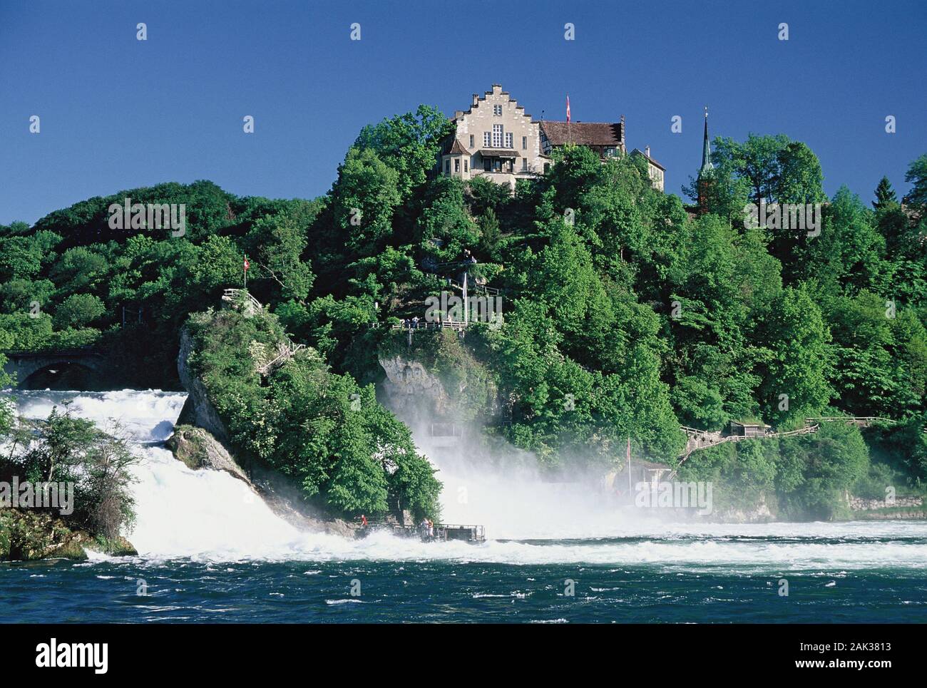 Roaring the water of the Rhine river floats down the rocks at the Rhine ...