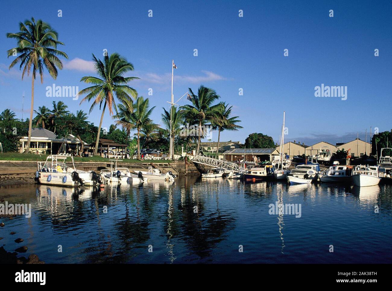 Boats and palm trees reflecting in the marina of the Royal Suva Yacht ...