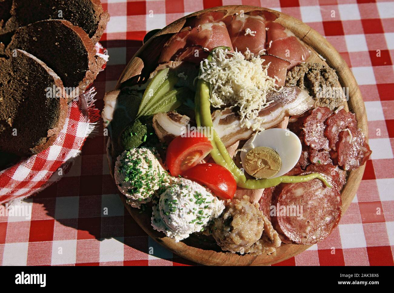 An Austrian meal consisting of bread, cold cuts, cheese, served on a ...