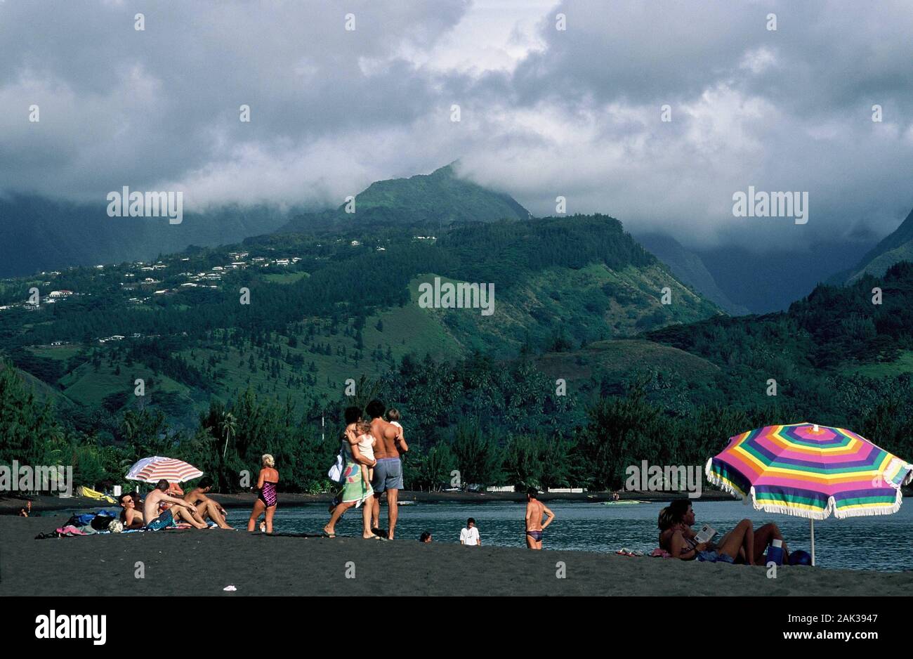 Volcanic sand tints the poular beach at Point Venus on the island of ...