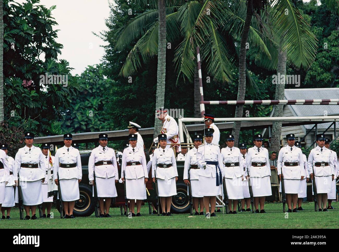 Members of the Royal Women's Guard dressed in a white uniform standing ...