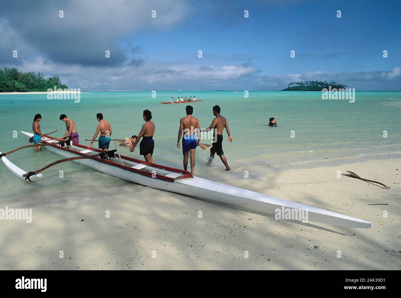 Locals of the Cook Islands training with their outrigger canoe at Muri ...