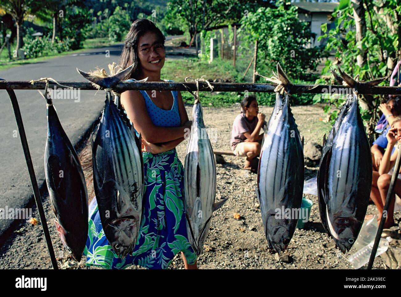 A local woman offers freshly caught tuna in the Cook's Bay on the ...