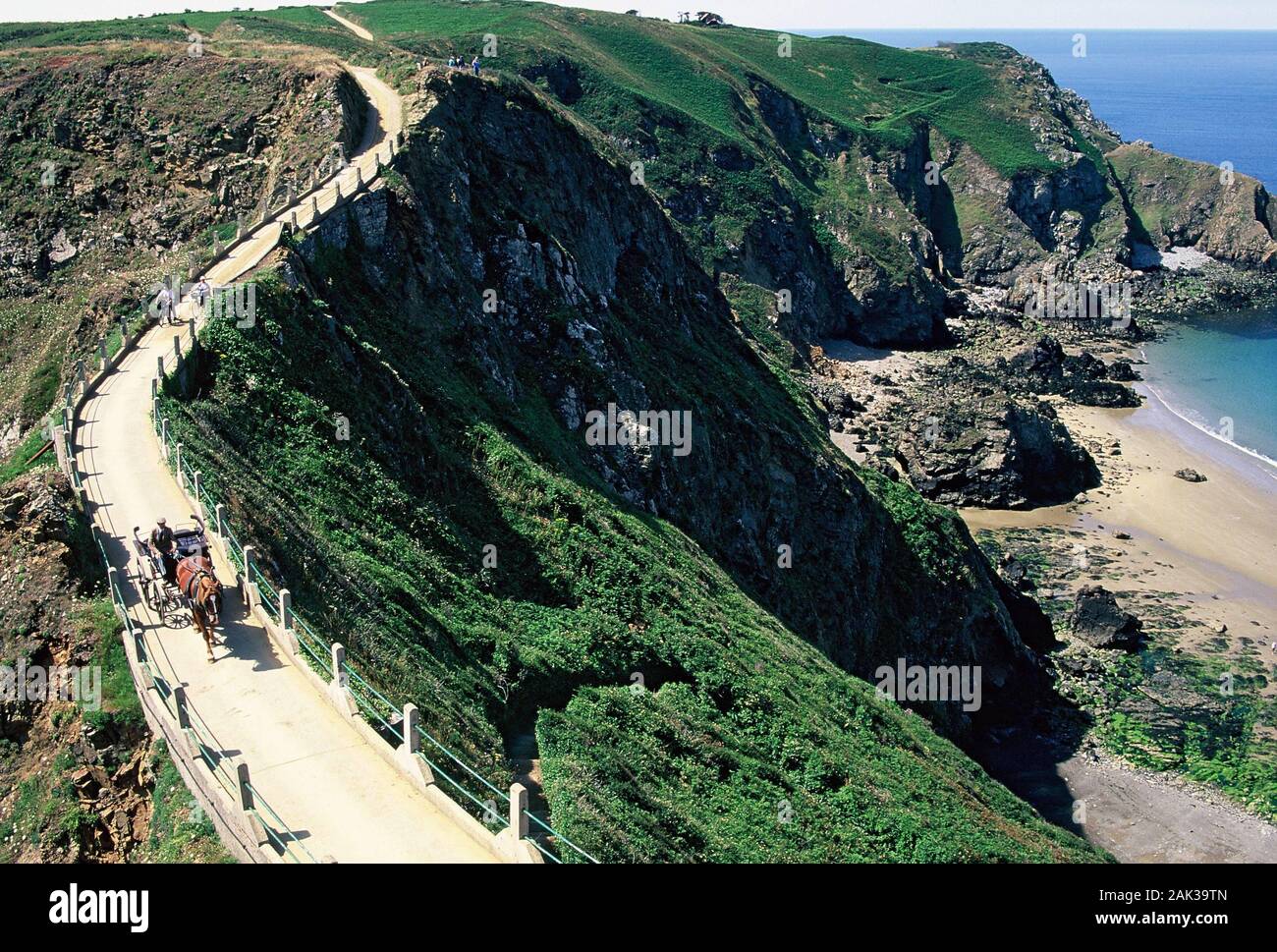 A narrow street leads across the headland of La Coupee on the island of ...