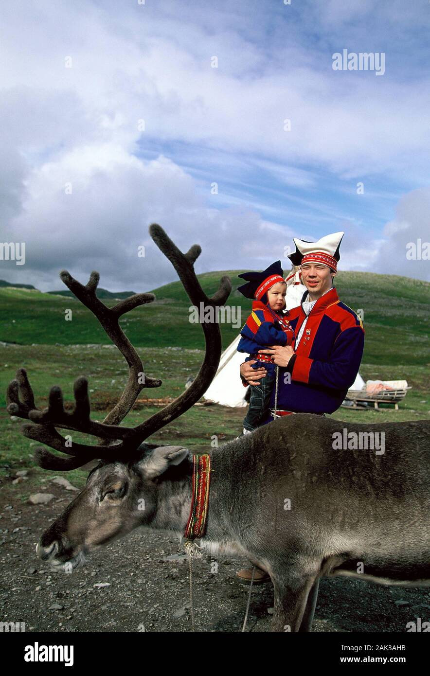 A man and a little child dressed in the traditional costumes of the ...