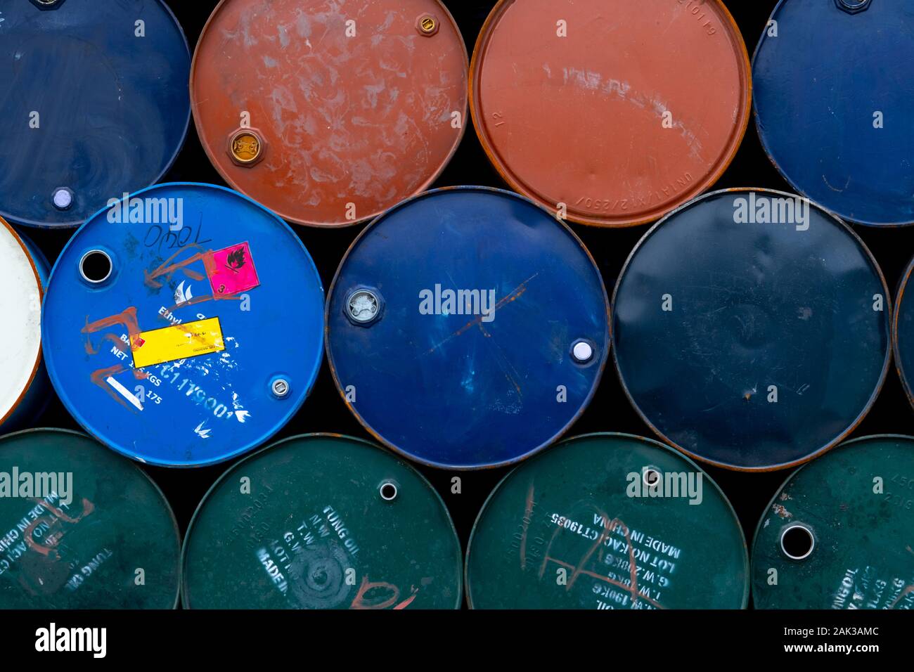 Old chemical barrels. Blue, green, orange oil drum. Steel oil tank ...