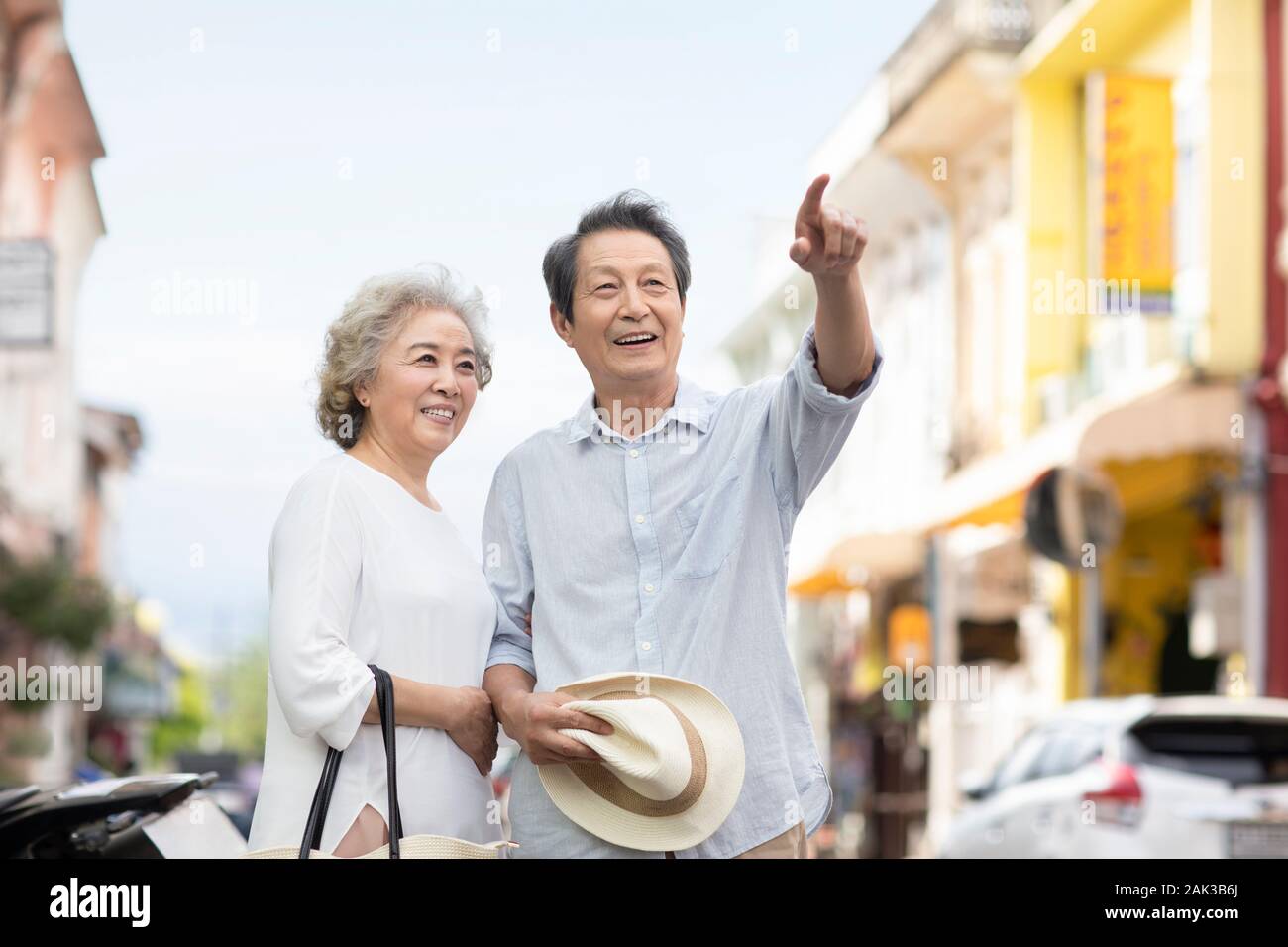 Happy senior Chinese couple standing on street Stock Photo - Alamy