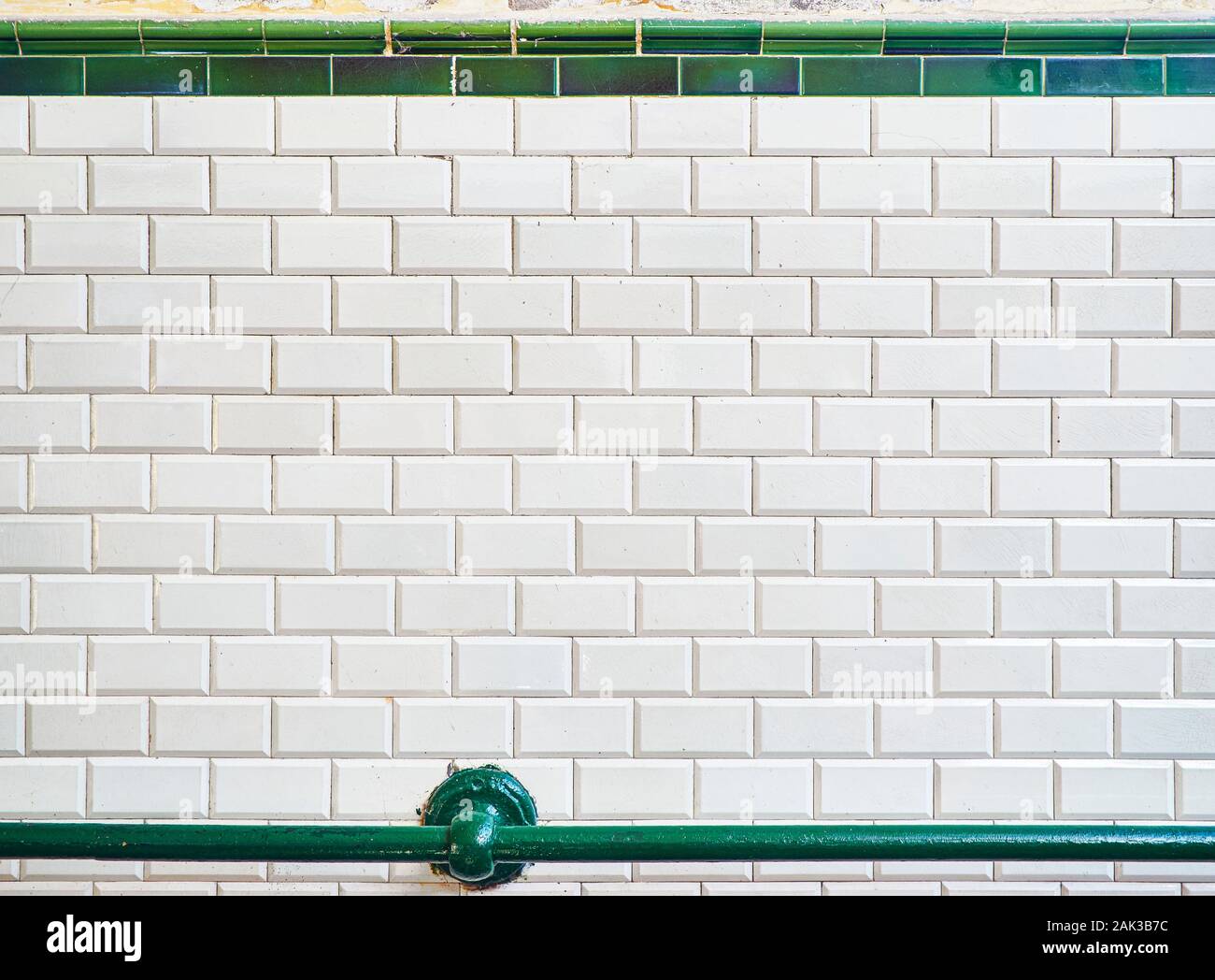 An antique wall tiled with Metro tiles background endowed with a green ...
