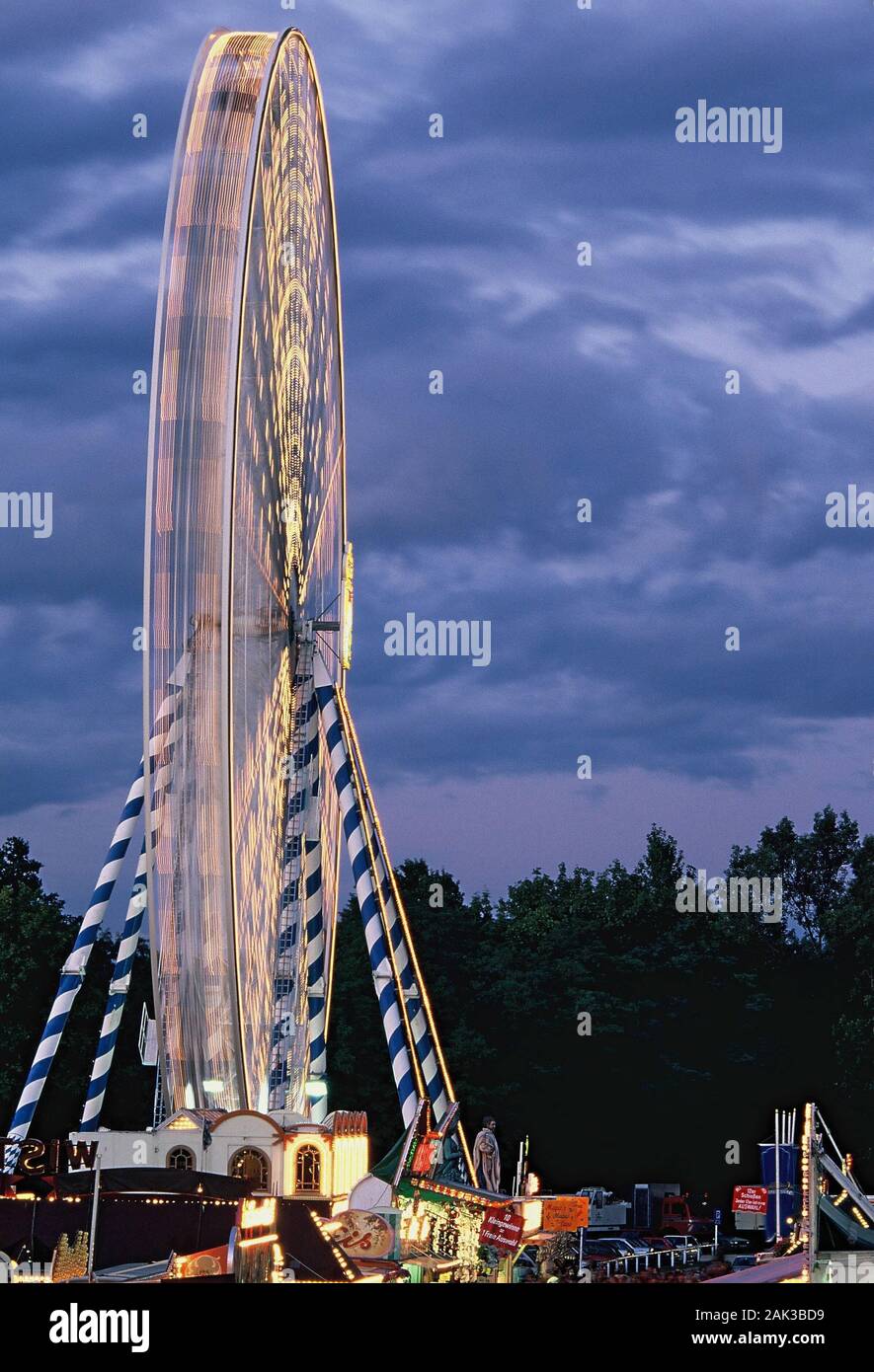 A ligthed big wheel rotating on the Nuremberg Folk Festival in ...