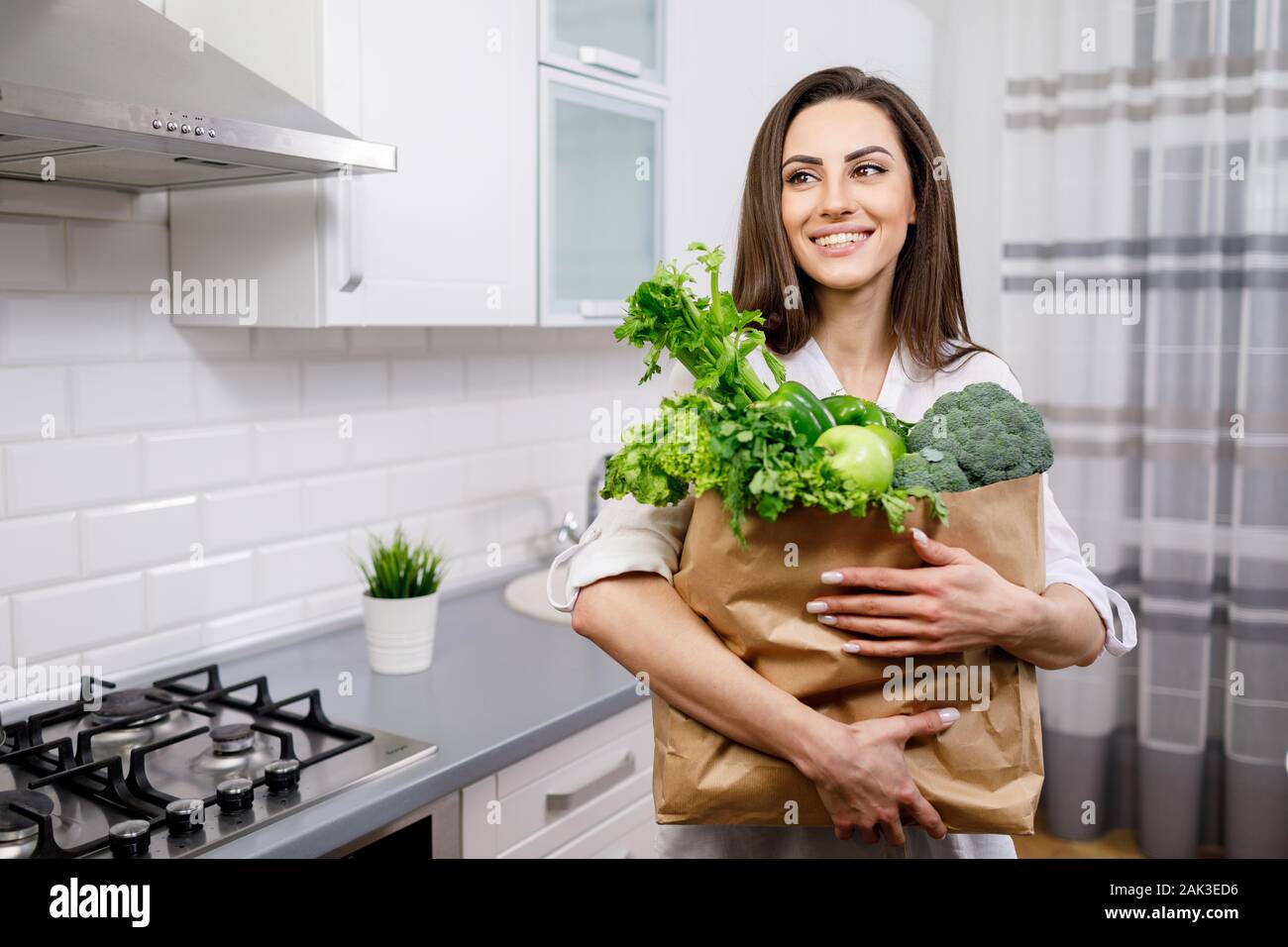 Smiling Young Lady Posing With Her Vegetable Purchases Stock Photo - Alamy