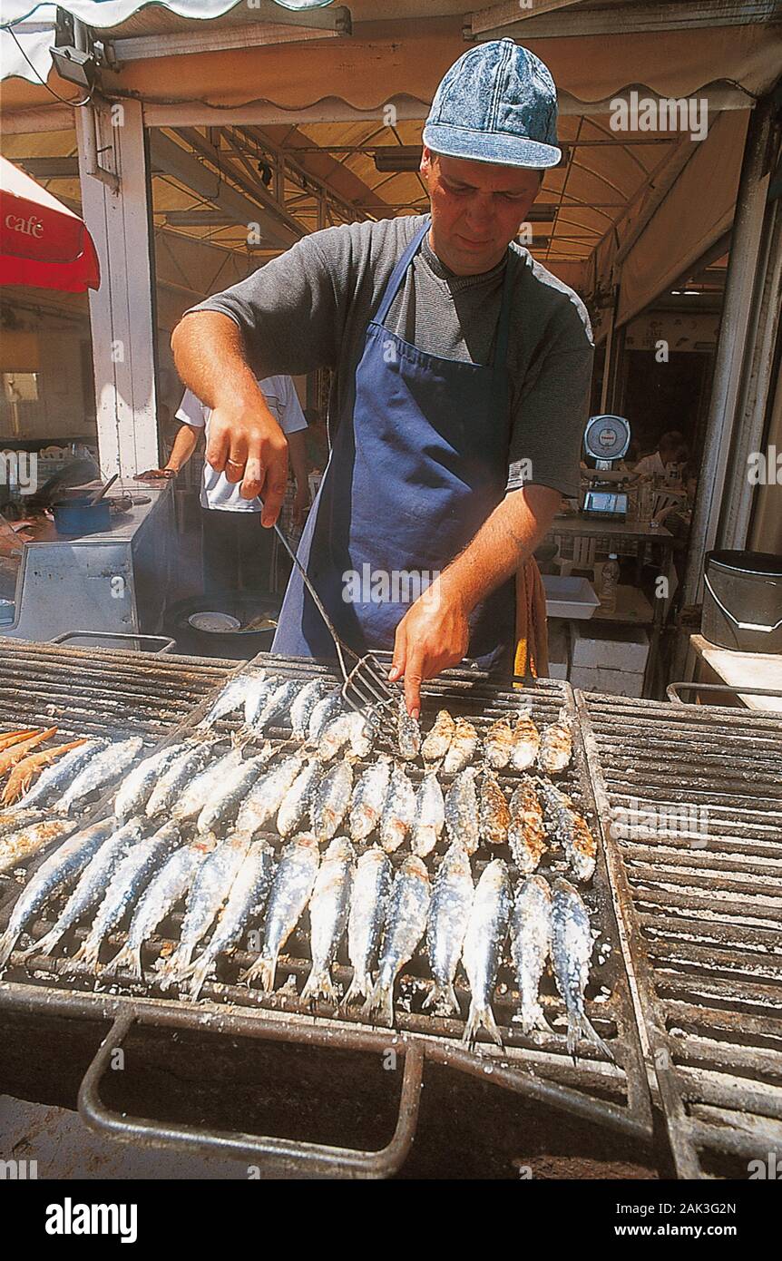 A man grilling sardines, the national dish in Portugal. (undated ...