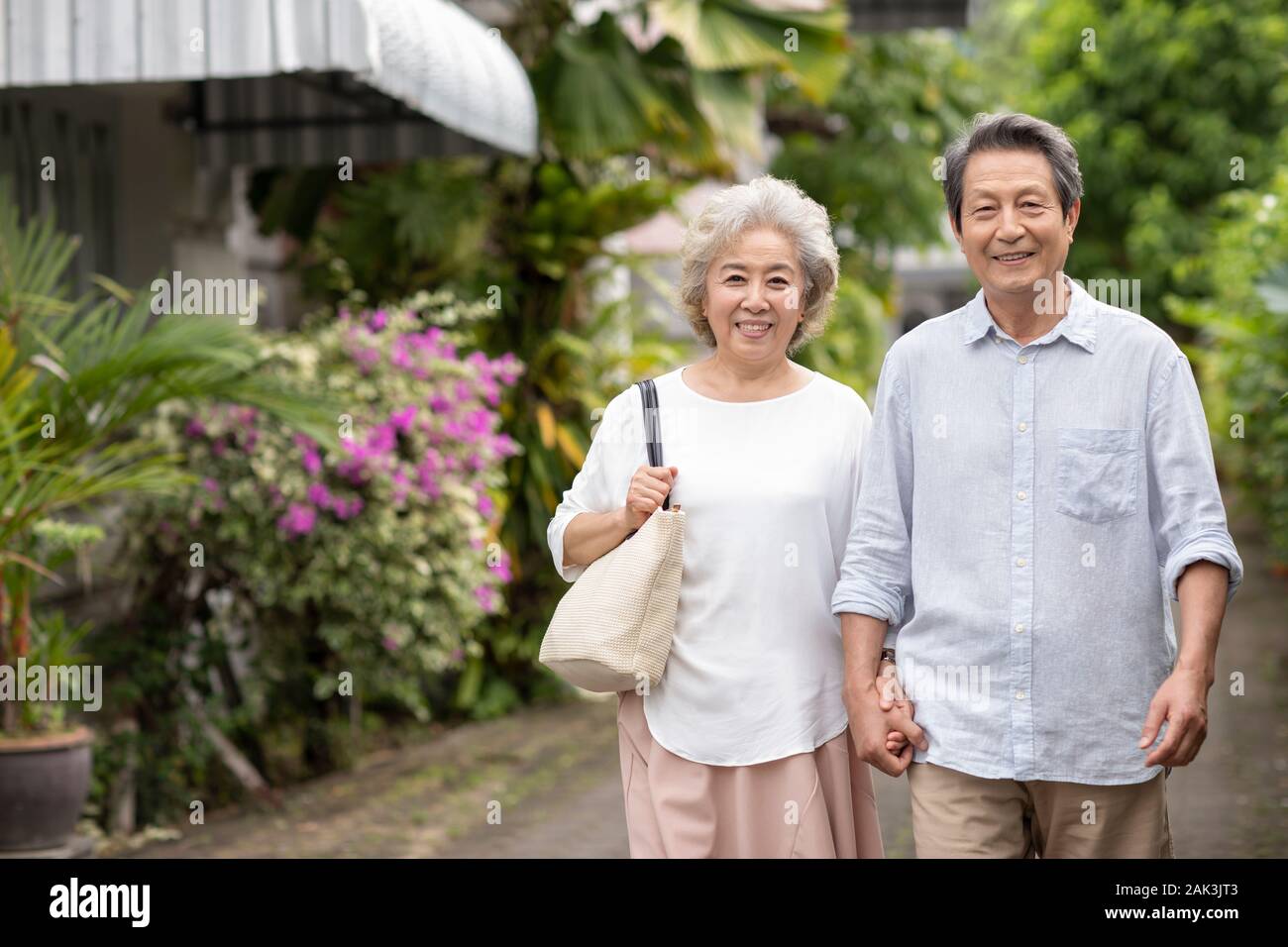 Happy senior Chinese couple holding hands Stock Photo - Alamy