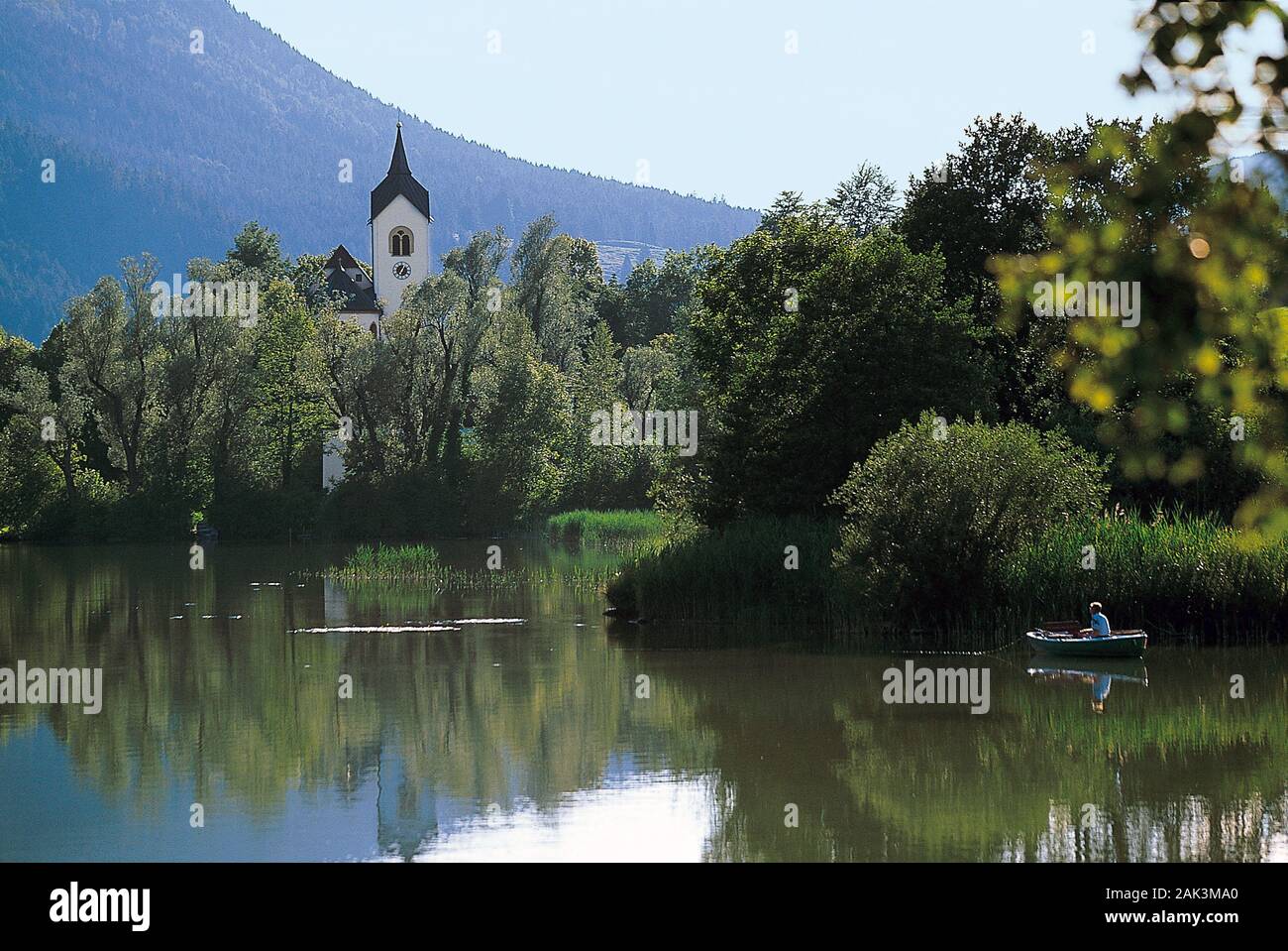 An angler tries his luck on the Forggensee in the Allgäu, Germany, with ...