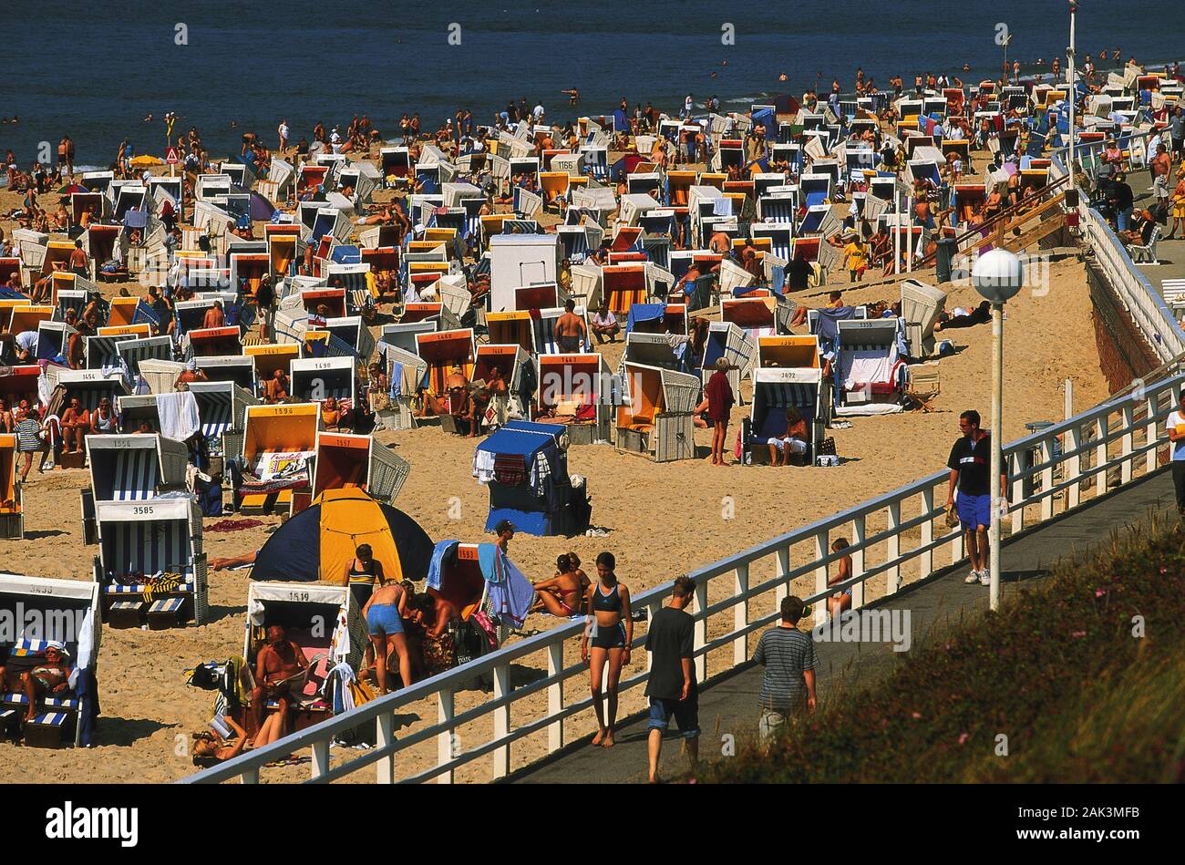 Spa visitors enjoy the summer weather on the beach of Westerland in ...