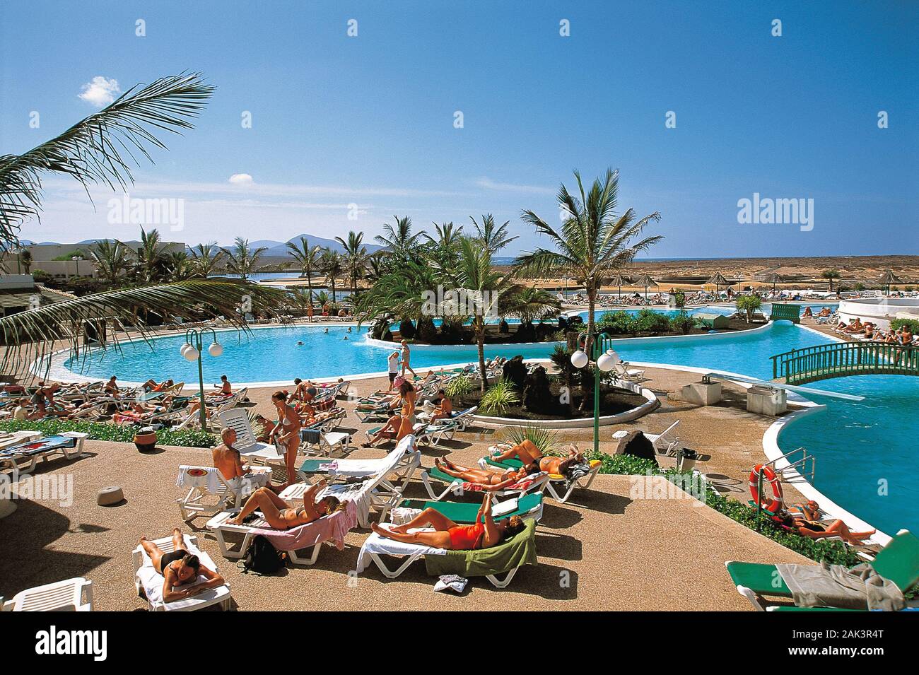 Vacationers relaxing at the pool of the Club La Santa in La Santa on ...