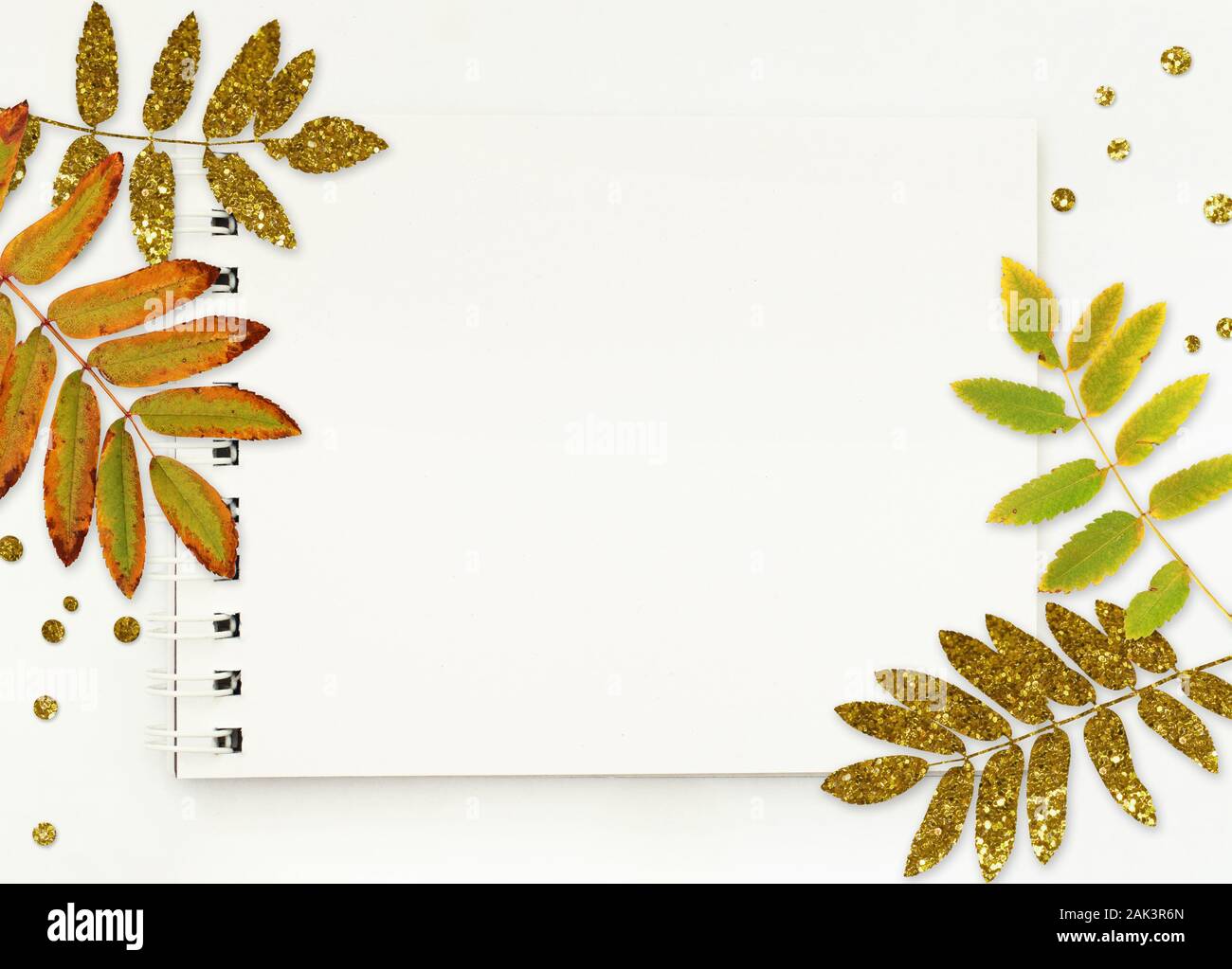 Notepad with white empty pages, autumn leaves and glitter confetti on ...