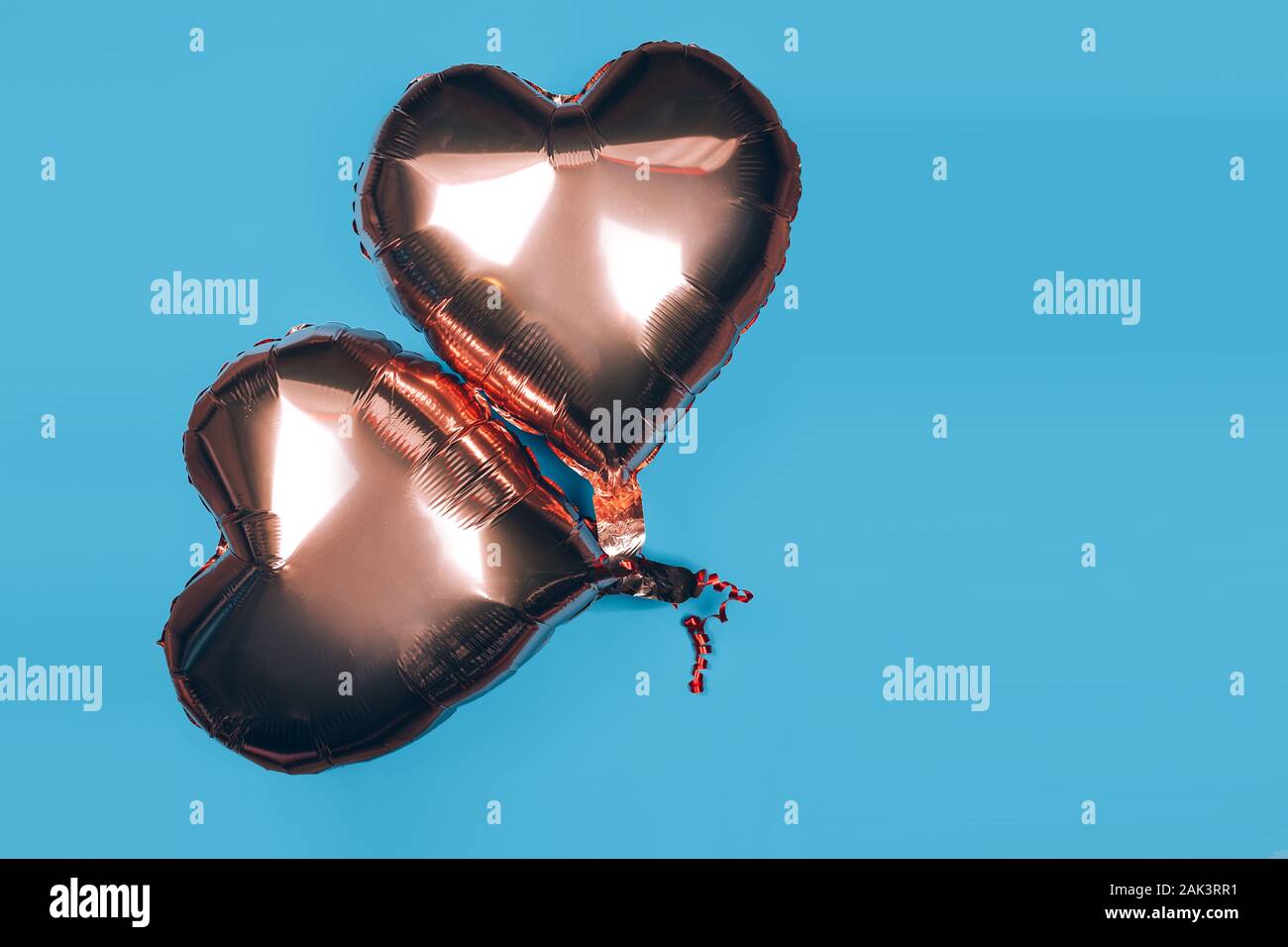 Two baloons heart shape on blue background Stock Photo - Alamy