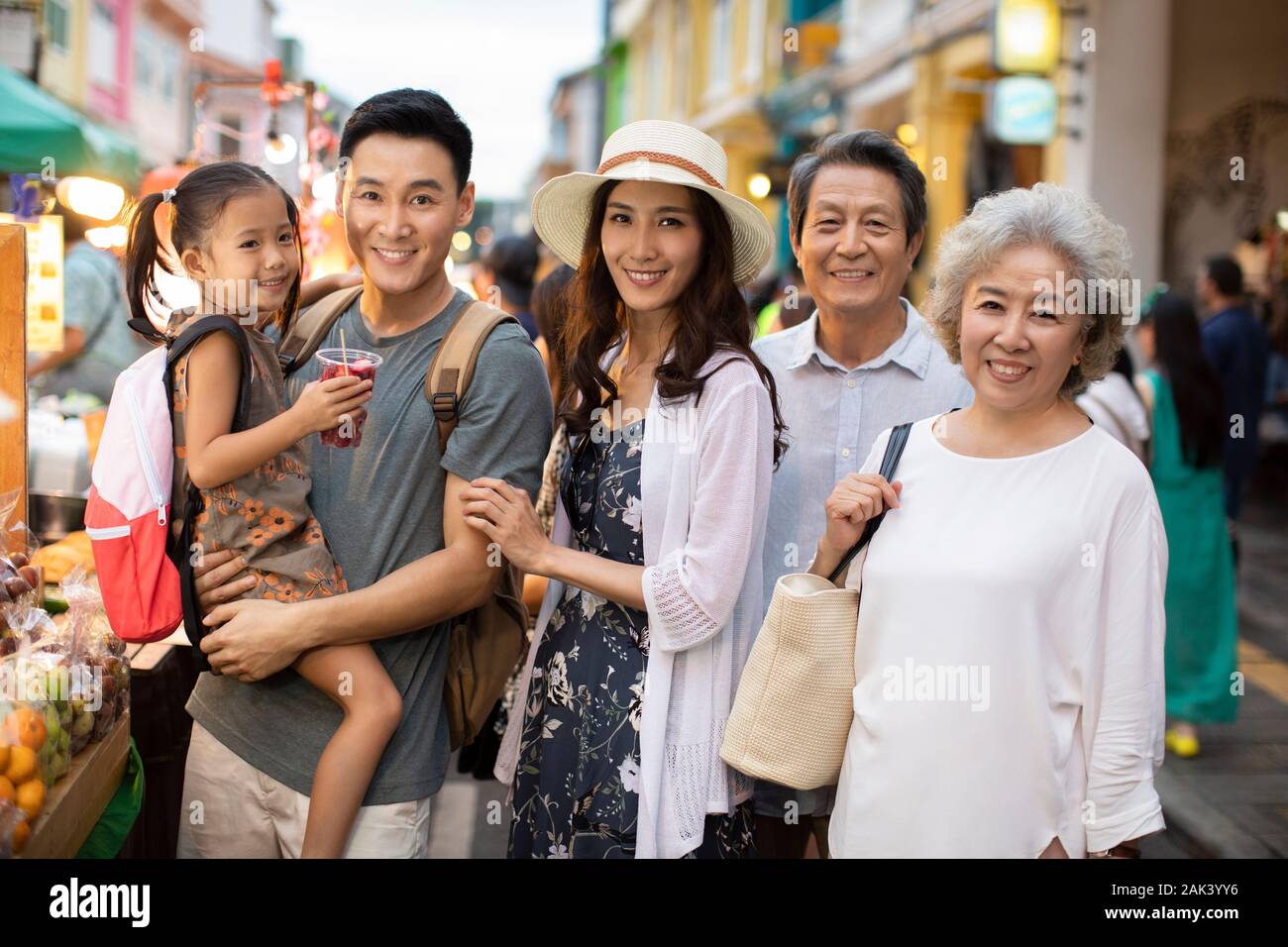 Happy Chinese family relaxing in street market Stock Photo - Alamy