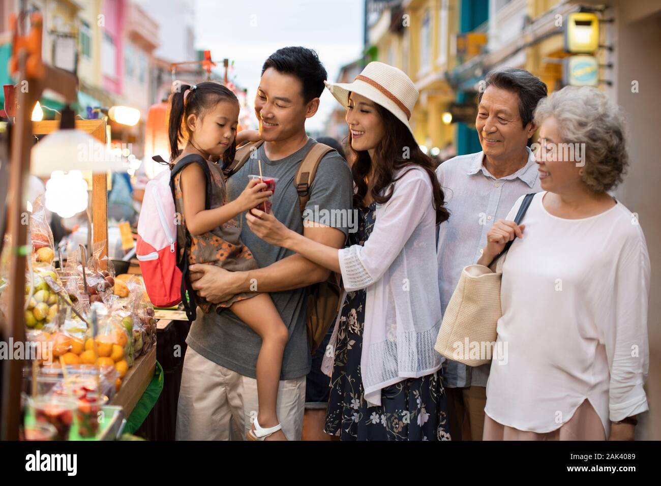 Happy Chinese family relaxing in street market Stock Photo - Alamy