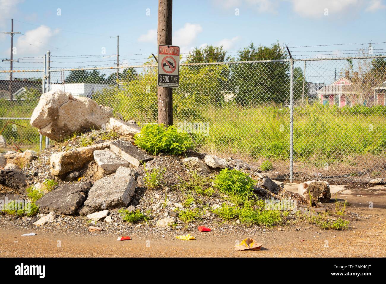 ironic image of No Dumping sign surrounded by dumped building rubble ...