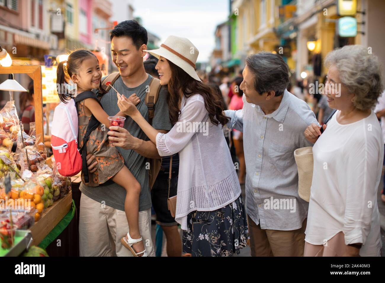 Happy Chinese family relaxing in street market Stock Photo - Alamy