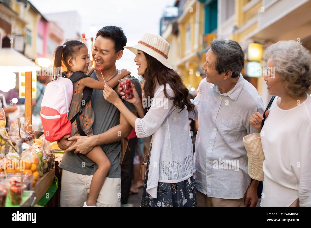 Happy Chinese family relaxing in street market Stock Photo - Alamy