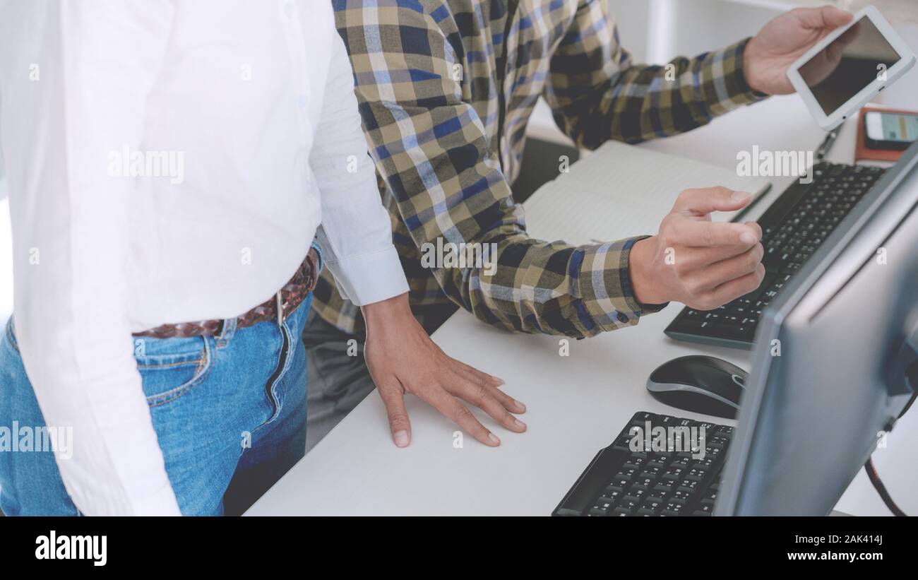 Young startup Programmers Sitting At Desks Working On Computers screen for Developing ...