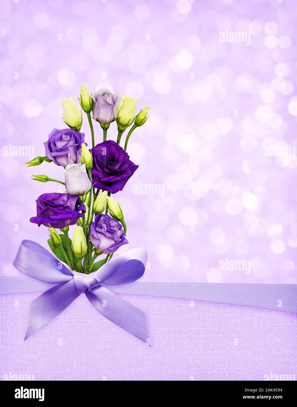 Lilac holiday bokeh background with silk bow and eustoma flowers ...