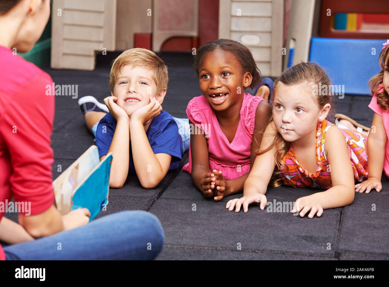 Children laughing while reading story hi-res stock photography and ...