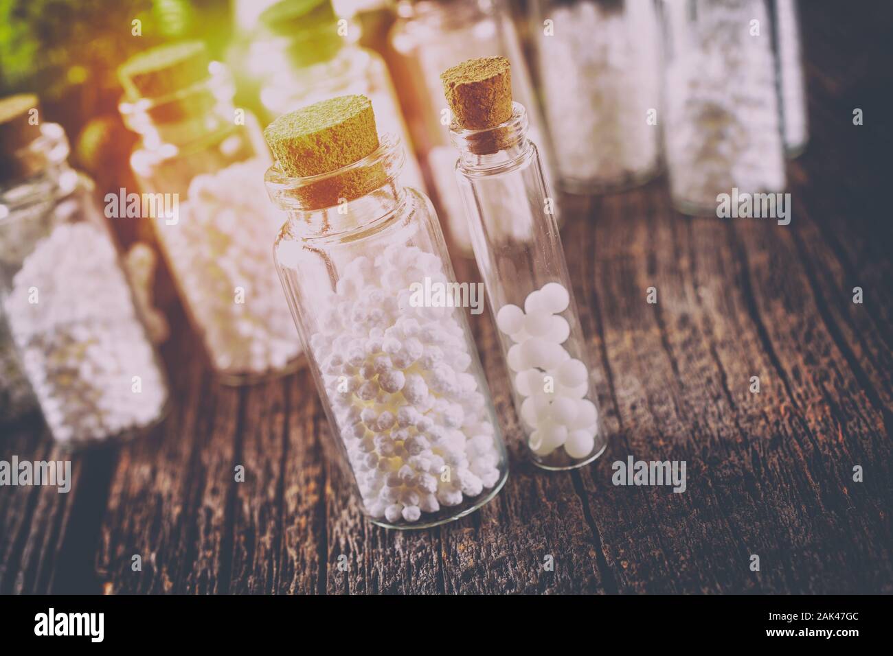 Homeopathic lactose sugar globules in glass bottles Stock Photo - Alamy