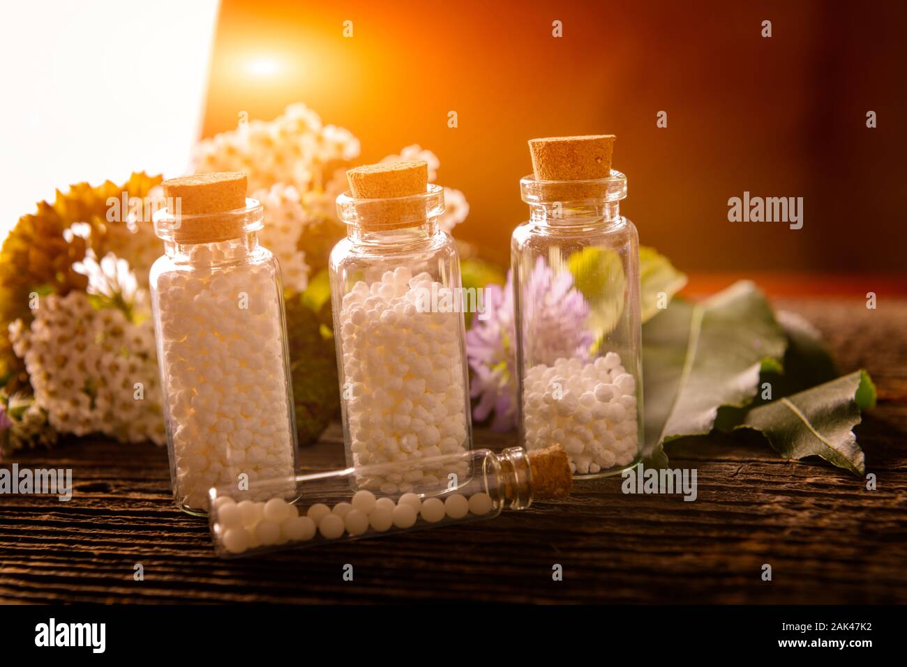 Homeopathic lactose sugar globules in glass bottles Stock Photo - Alamy