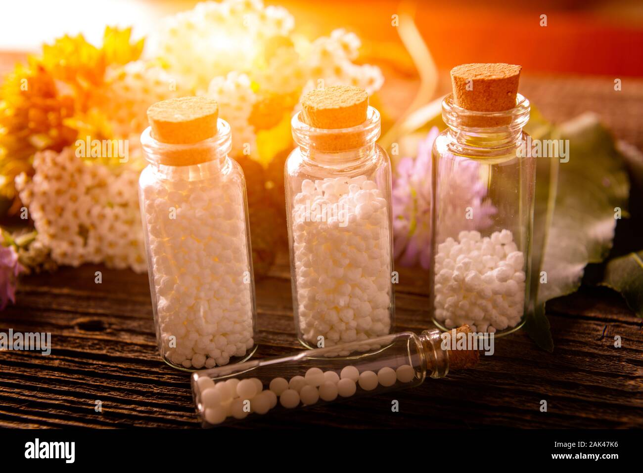 Homeopathic lactose sugar globules in glass bottles Stock Photo - Alamy