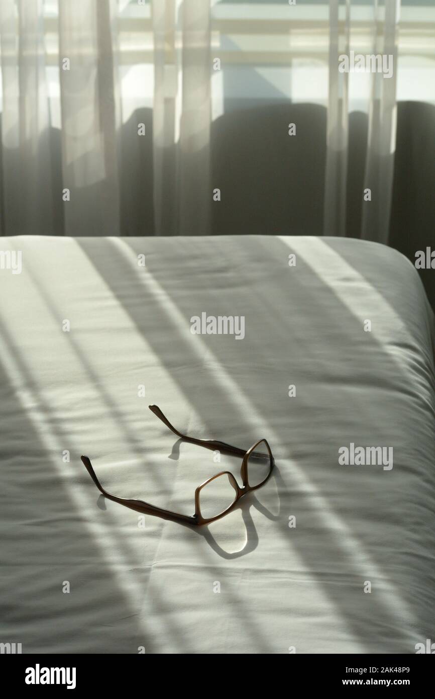 Glasses left on a bed in a hotel room Stock Photo - Alamy