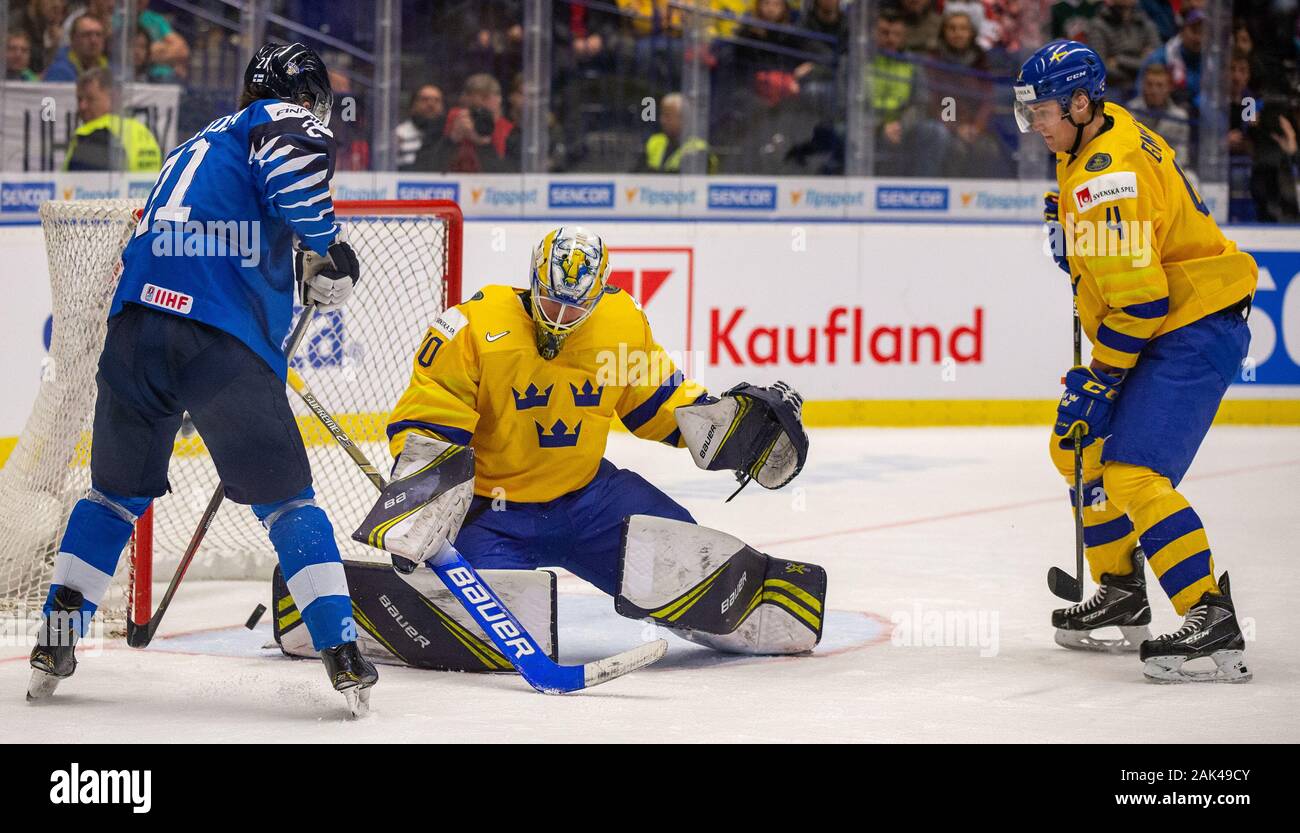 L-R Patrik Puistola (FIN) and goalkeeper Hugo Alnefelt and Adam Ginning (both SWE) in action ...