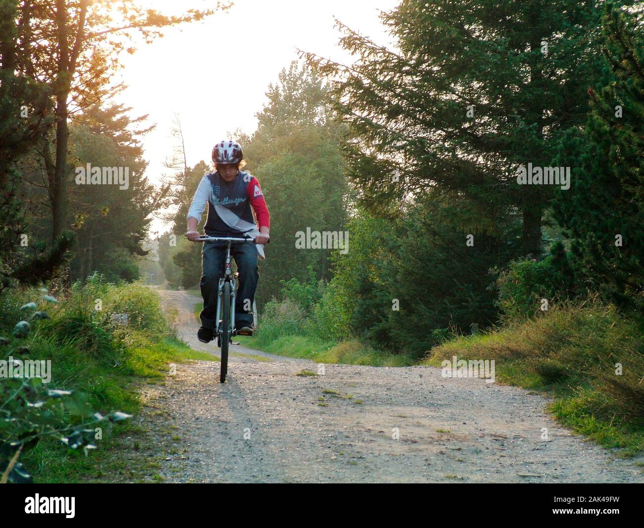 Boy riding bicycle Stock Photo - Alamy