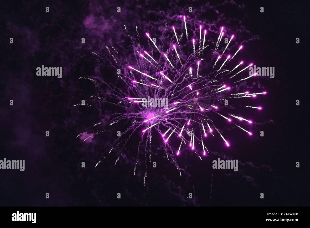 Beautiful pink fireworks in the dark sky Stock Photo - Alamy