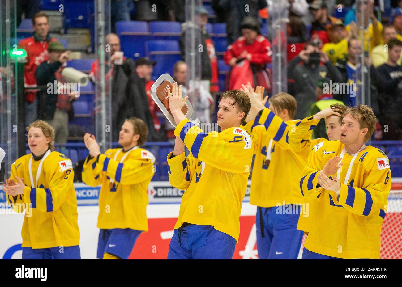 Swedish team's captain Adam Ginning, centre, and Rasmus Sandin, right ...
