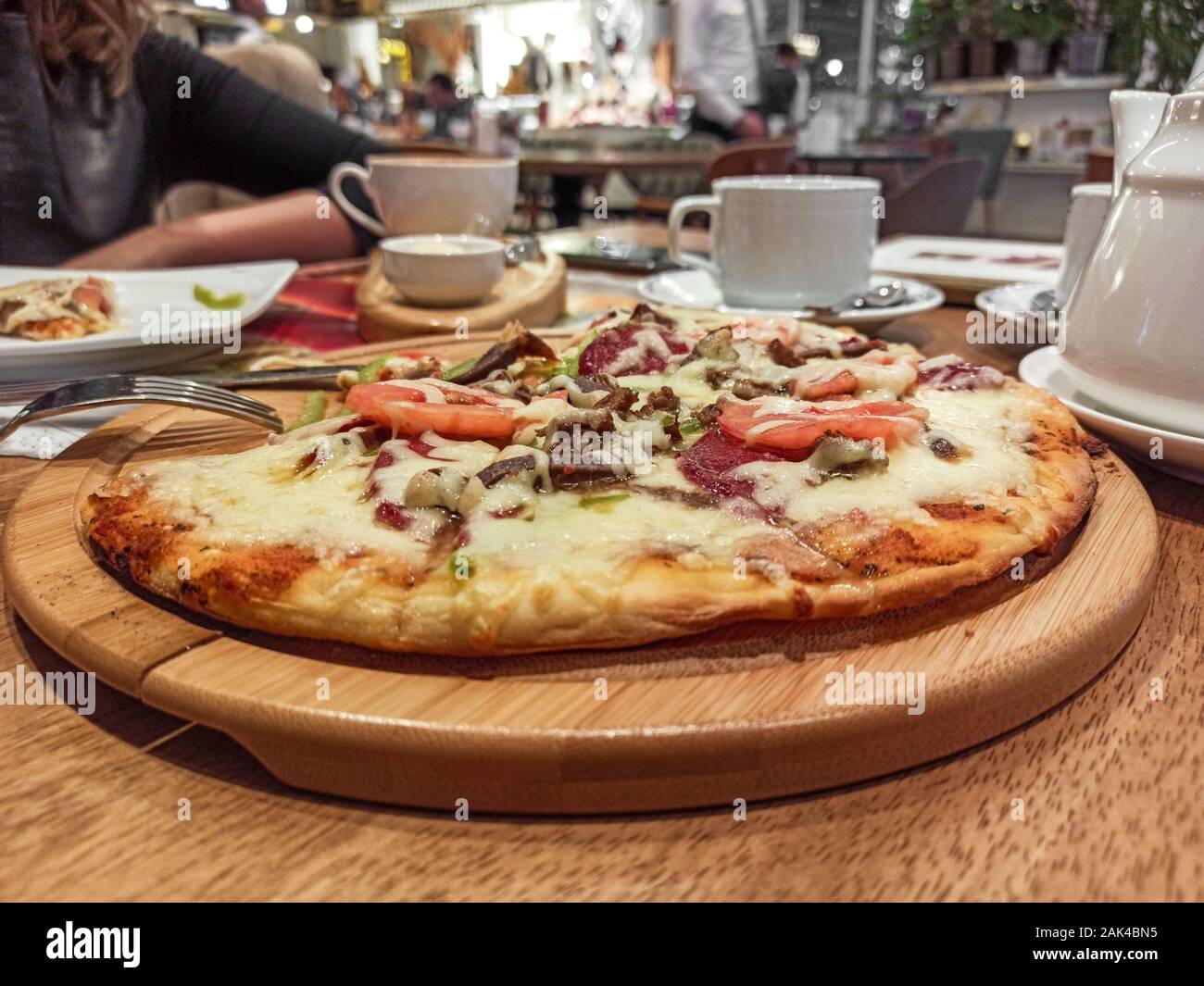 round pide or Turkish pizza with cheese, sujuk and different types of ...