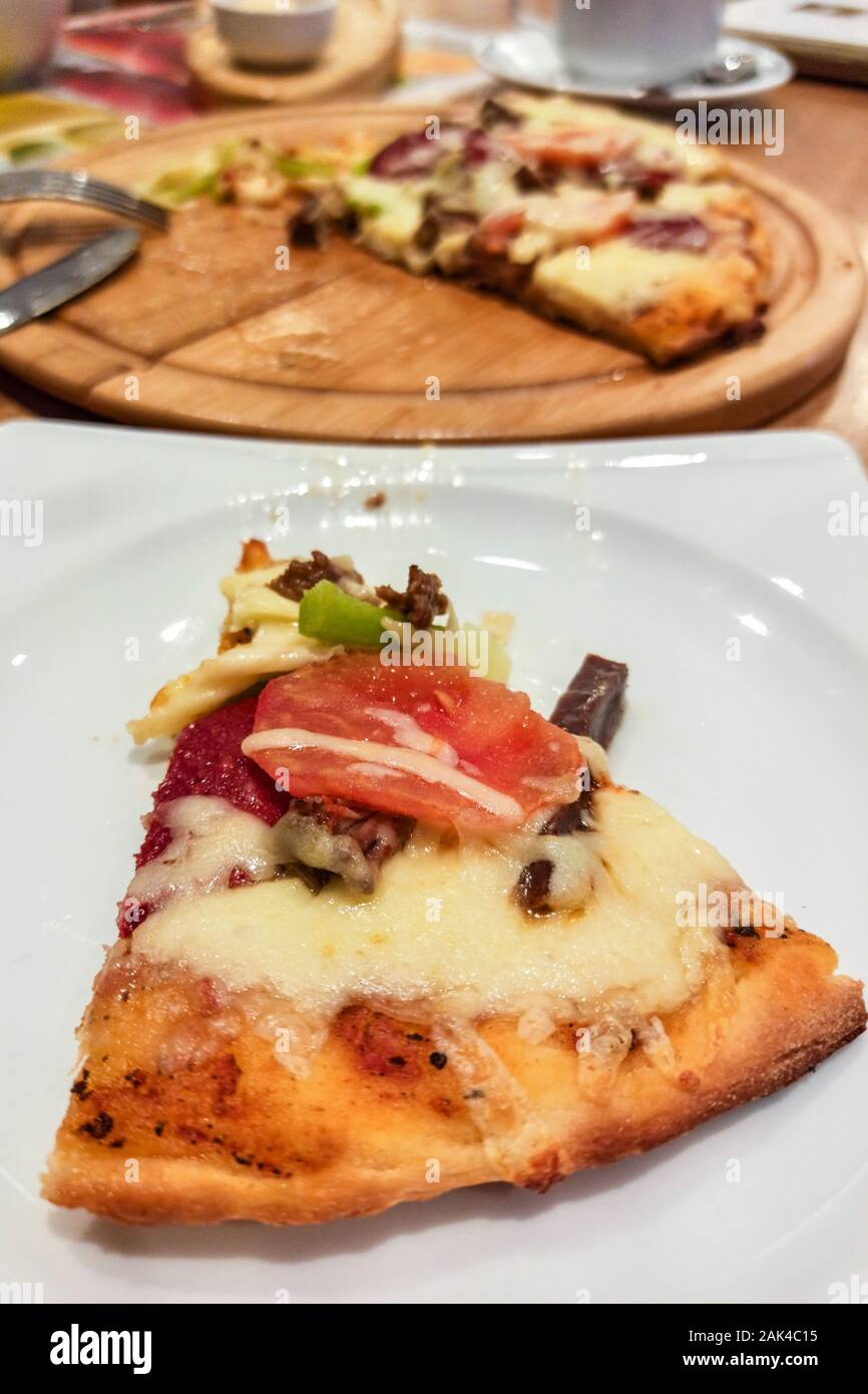round pide or Turkish pizza with cheese, sujuk and different types of ...