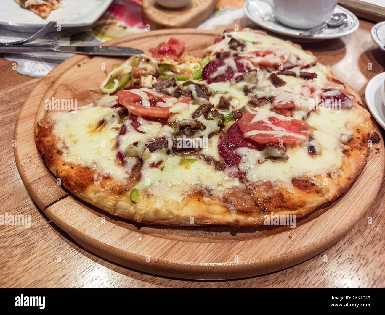round pide or Turkish pizza with cheese, sujuk and different types of ...