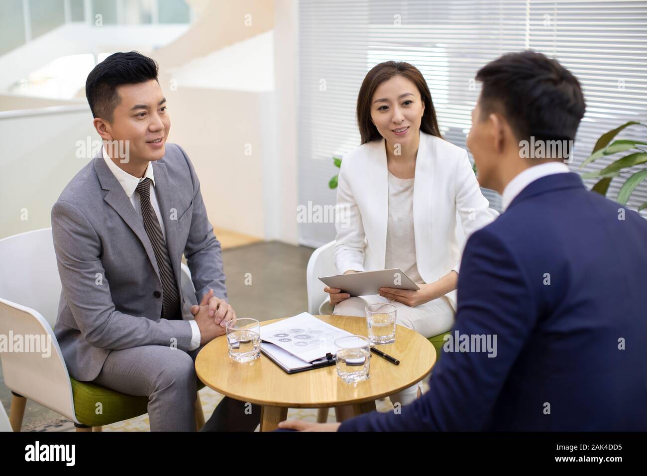 Chinese business people talking in office Stock Photo - Alamy