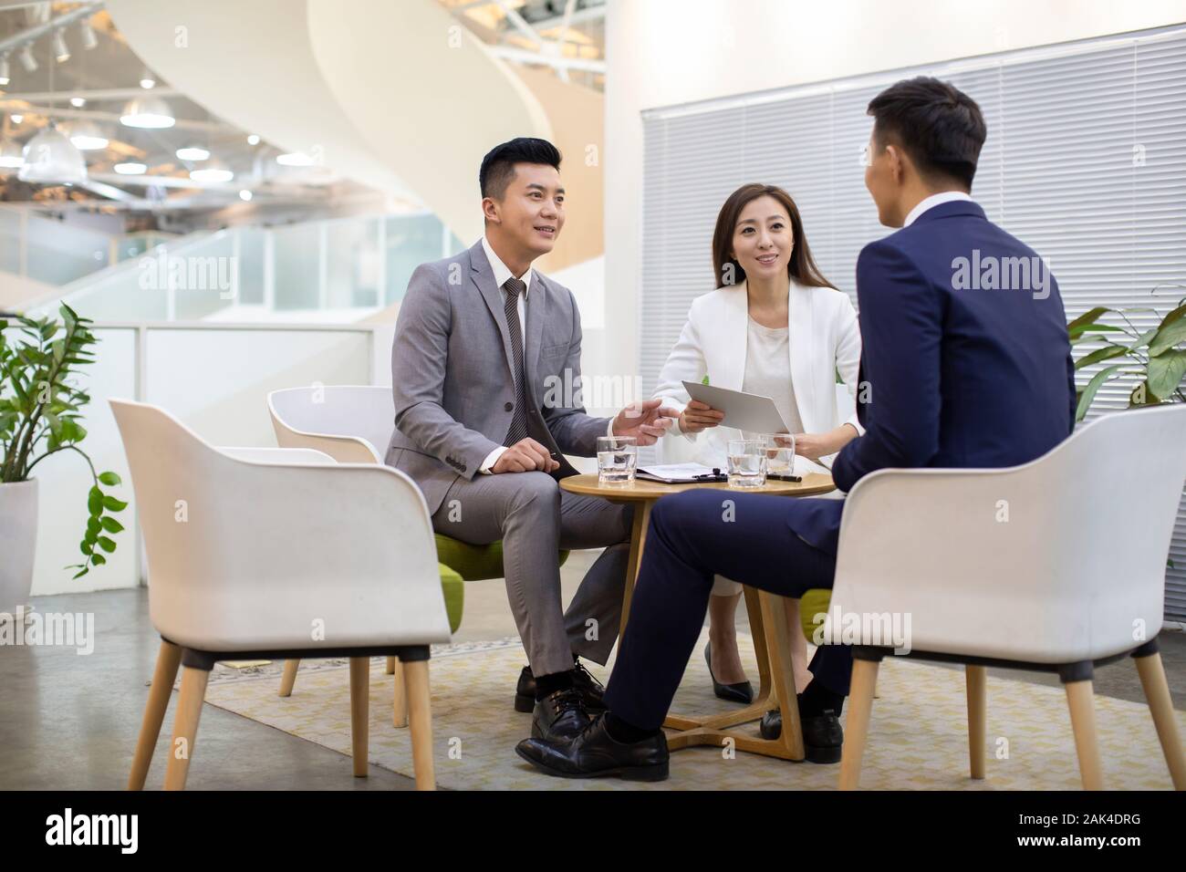 Chinese business people talking in office Stock Photo - Alamy