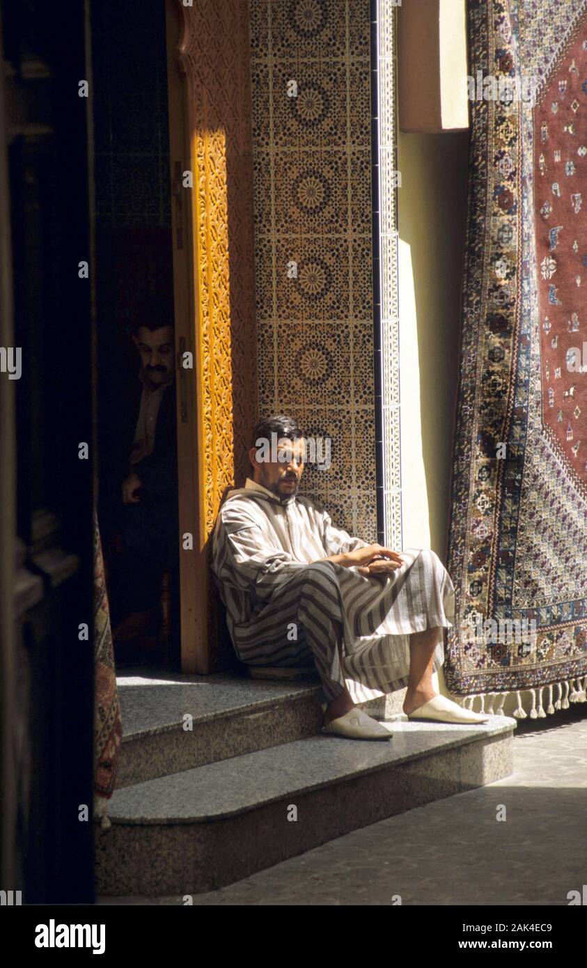 Morocco - Pausing merchant is sitting on the steps at the Petit Socco ...