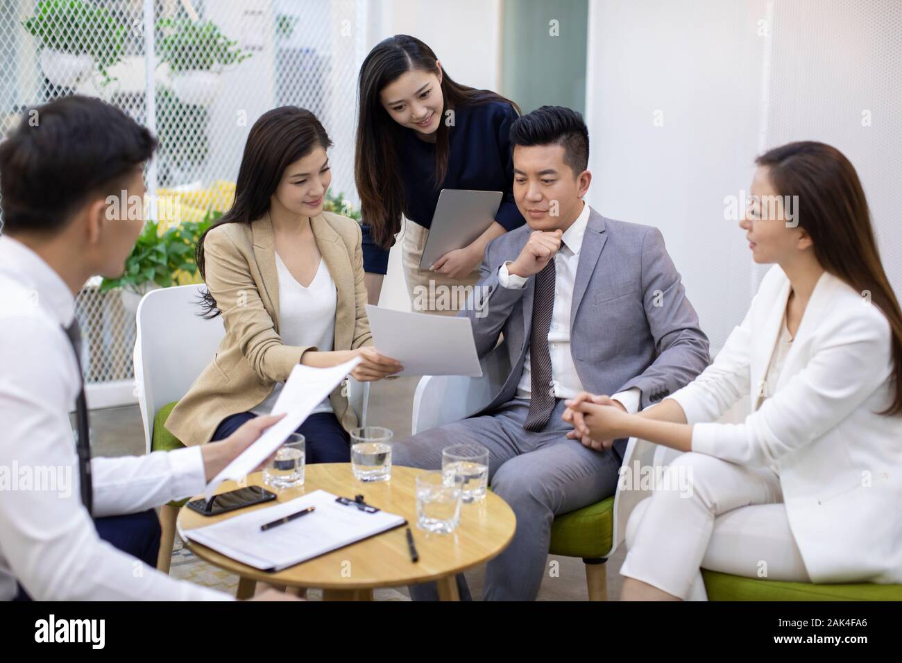 Chinese business people having a meeting in office Stock Photo - Alamy