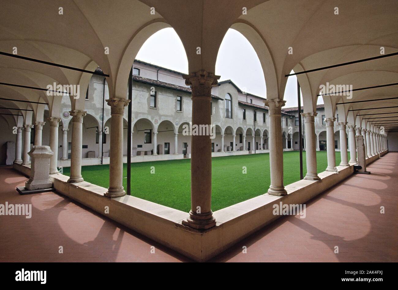 A cloister surrounds a leafy inner courtyard in the former monastery of ...
